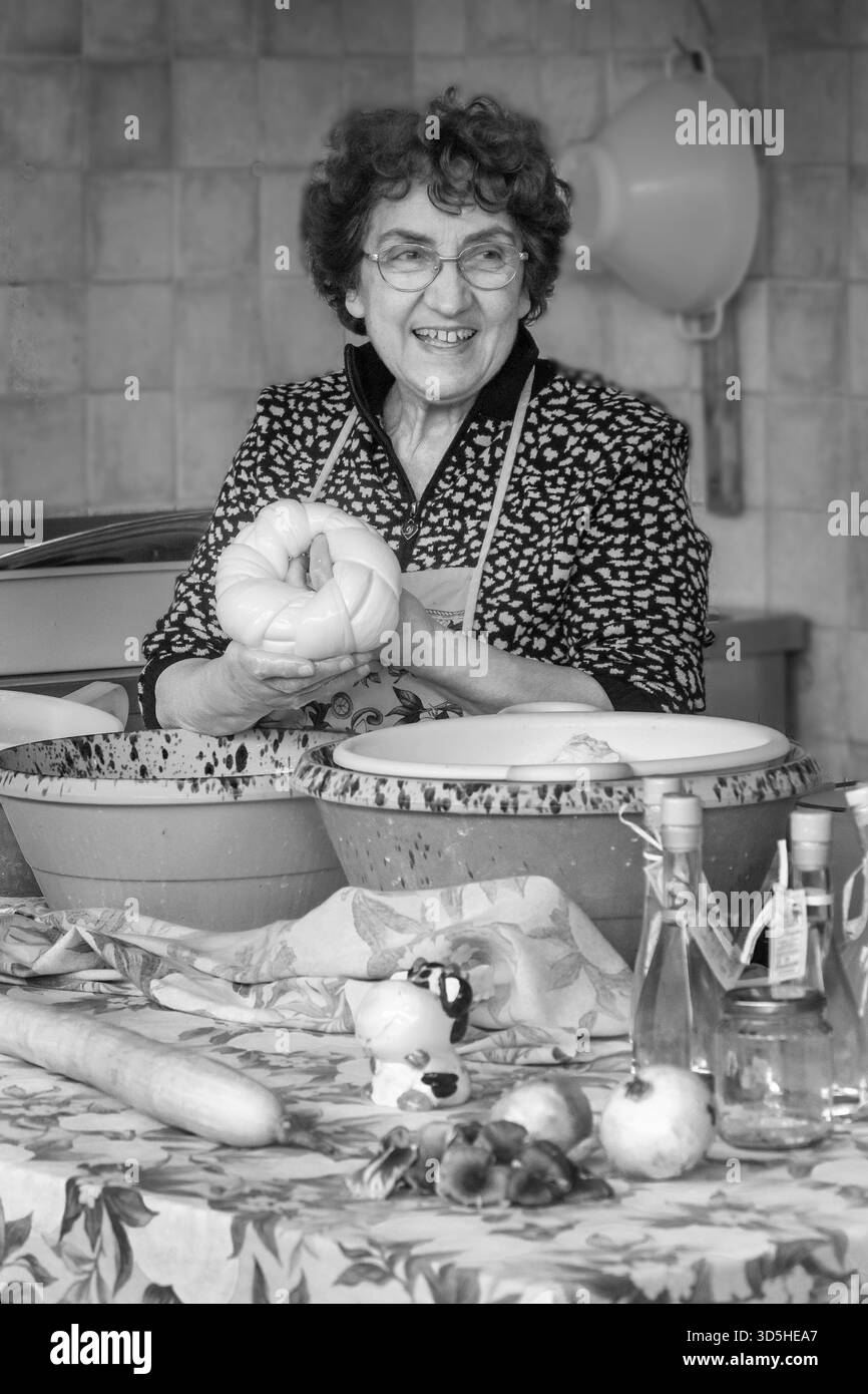 Italian farmers wife making Mozzarella chesse in the traditional way on ...