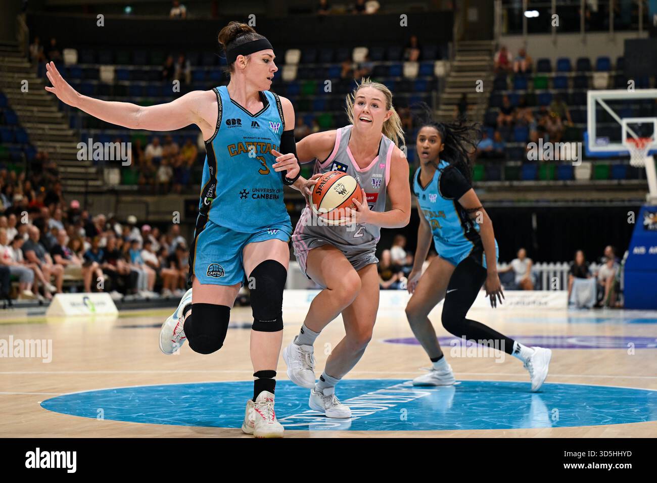 Teige Morrell of the Capitals fights for the ball with Isabelle Morgan ...