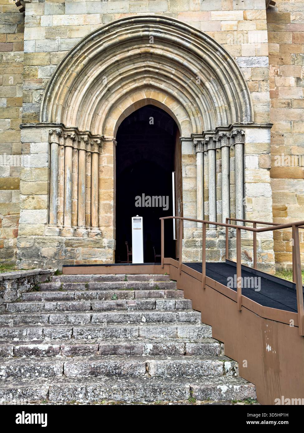 Historic Romanesque entrance with layered arches and weathered stone ...
