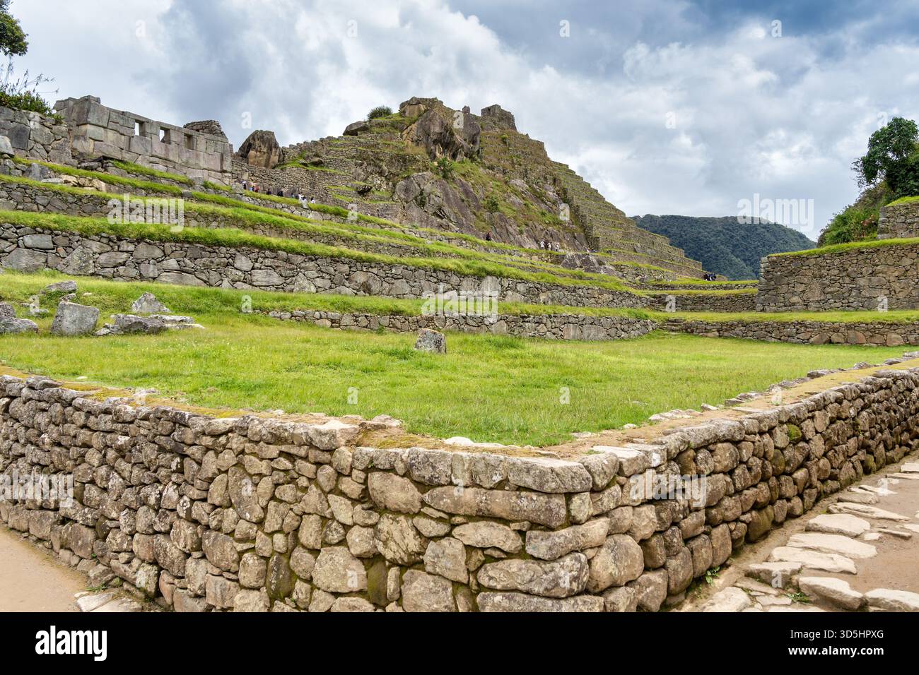 Tourists visiting the Incan ruins at Historic Sanctuary of Machu Picchu ...