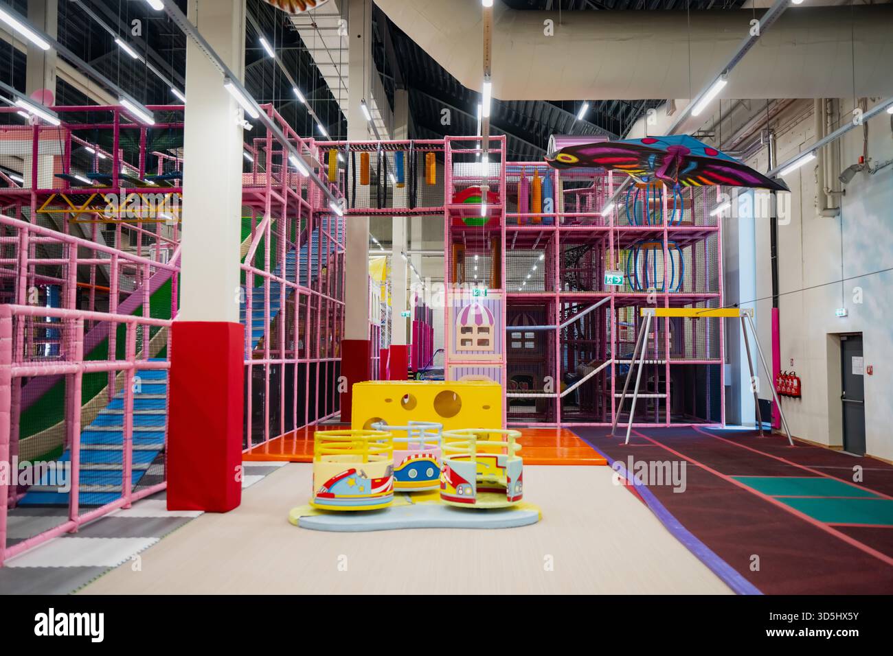 Large indoor children playground with bright climbing towers, maze ...