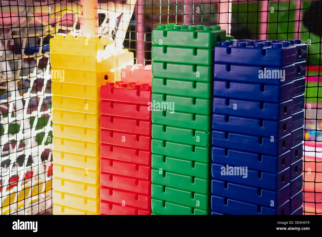 Tall stacks of vibrant plastic building blocks in yellow, red, green ...