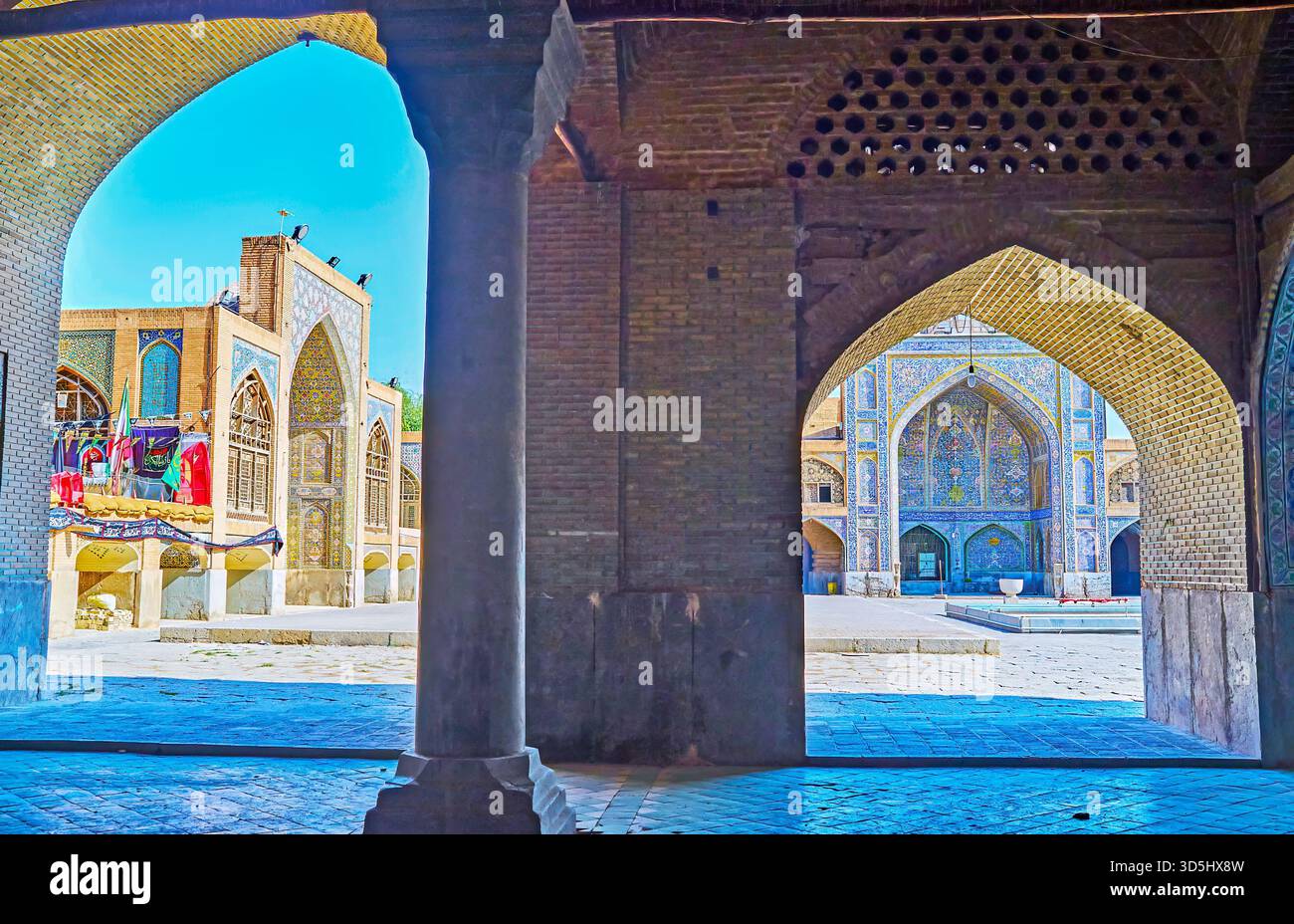 The brick arcade of Seyed Mosque opens the view on its courtyard (sahn ...