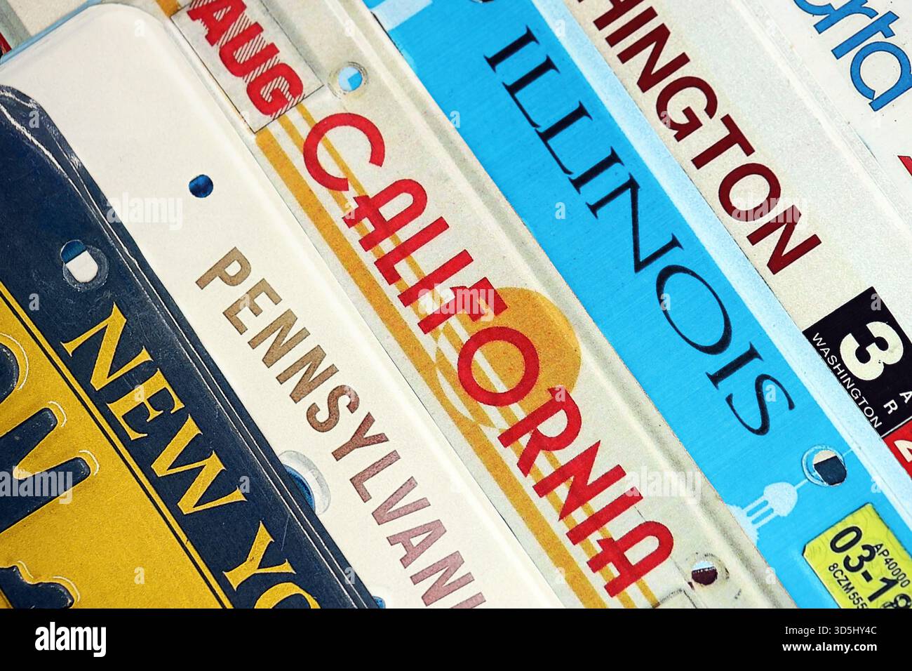 Old US car license plates with various state names. Concept of driving ...