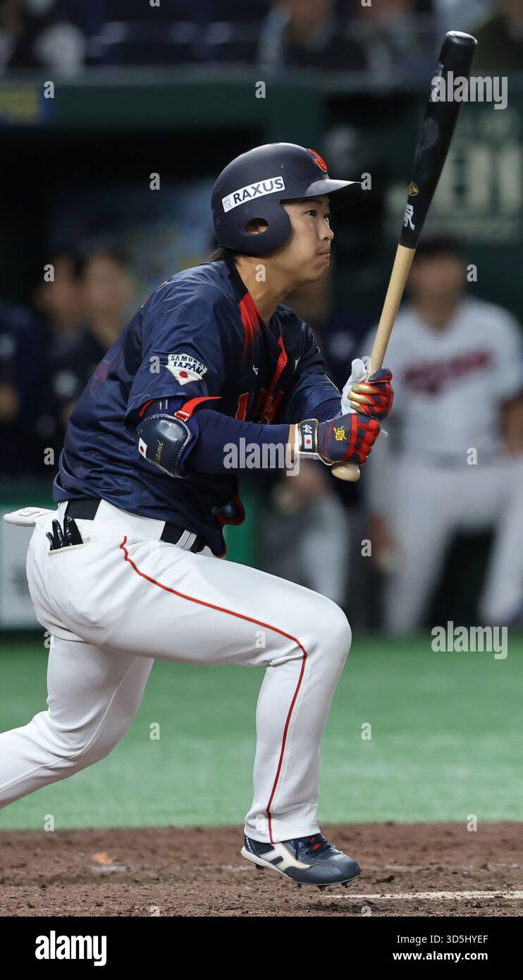 Japan Team second baseman ISHIKAMI Taiki hits a timely single in the ...