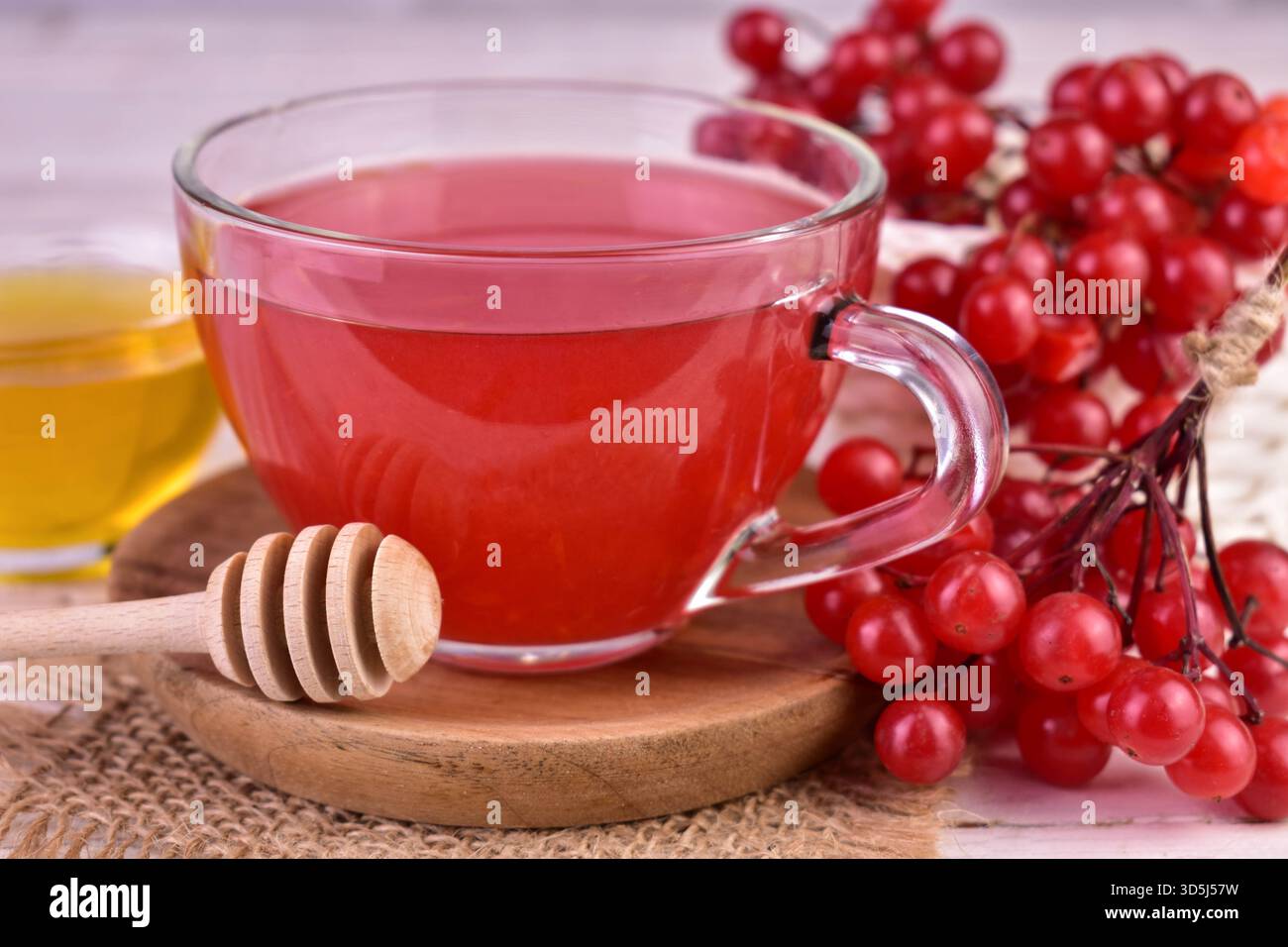 Viburnum berry tea in a transparent cup. Close-up. Medicinal tea for ...