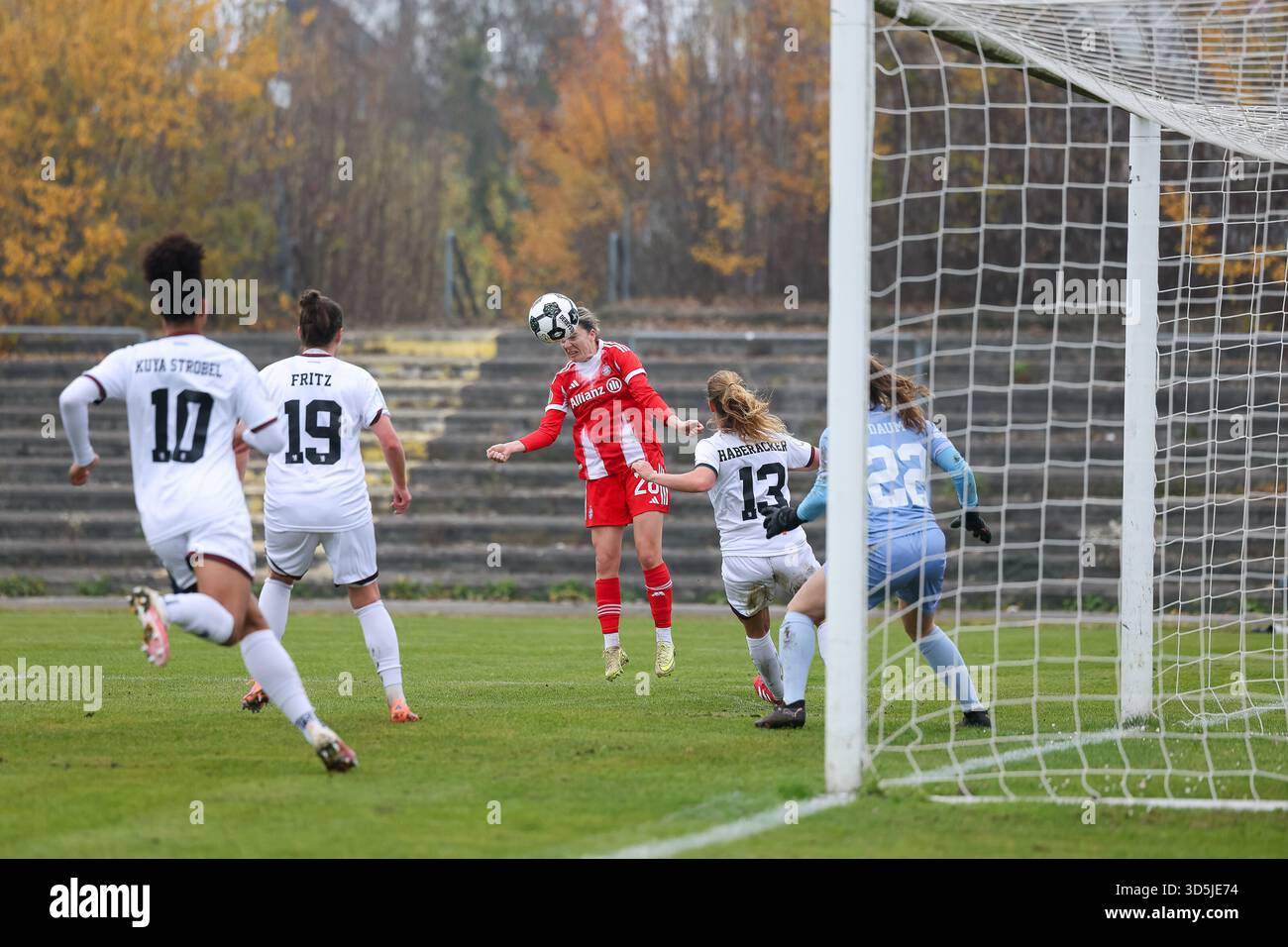 Barbara Dunst (FC FC Bayern Munich, #28) heading the ball with Leonie ...