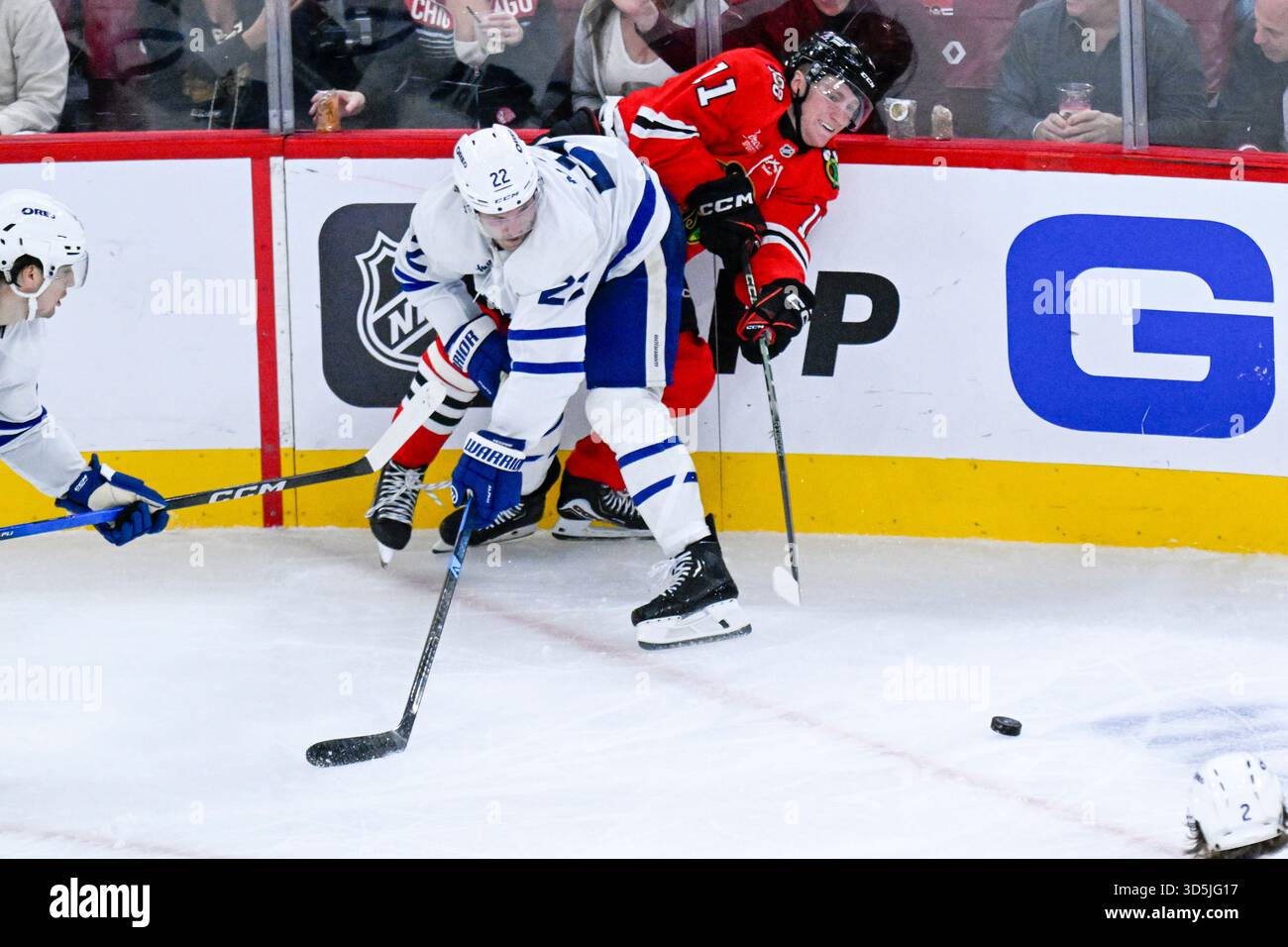 Chicago Blackhawks center Oliver Moore (11) passes the puck past ...