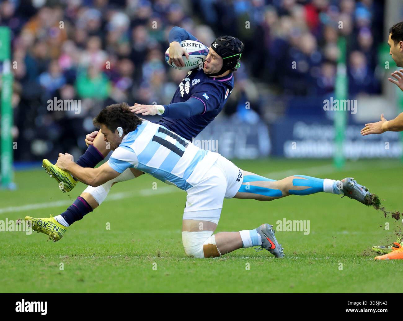 Scotland's Darcy Graham (rear) is tackled by Argentina's Mateo Carreras ...