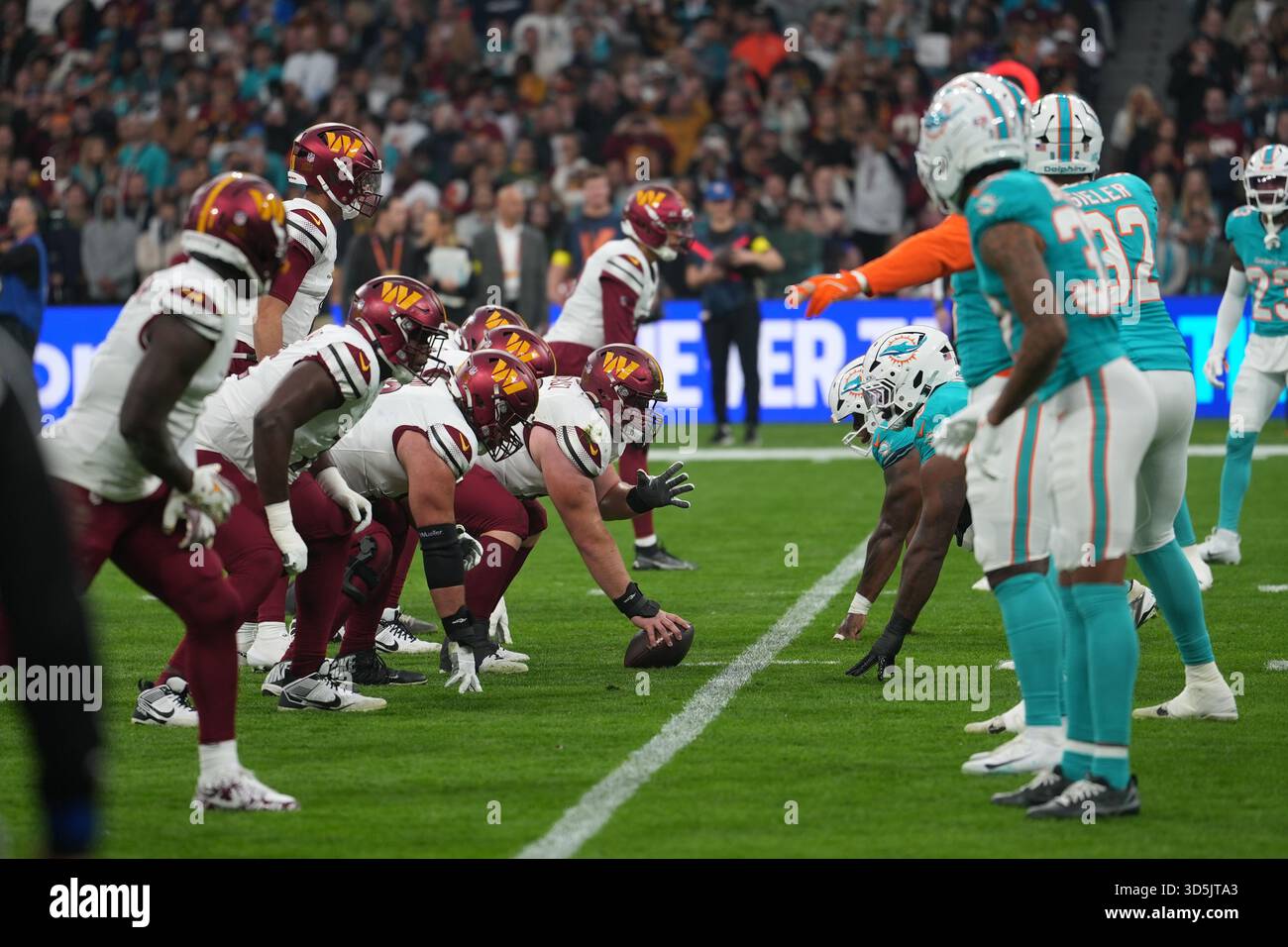The Washington Commanders and Miami Dolphins line up for a play in the ...