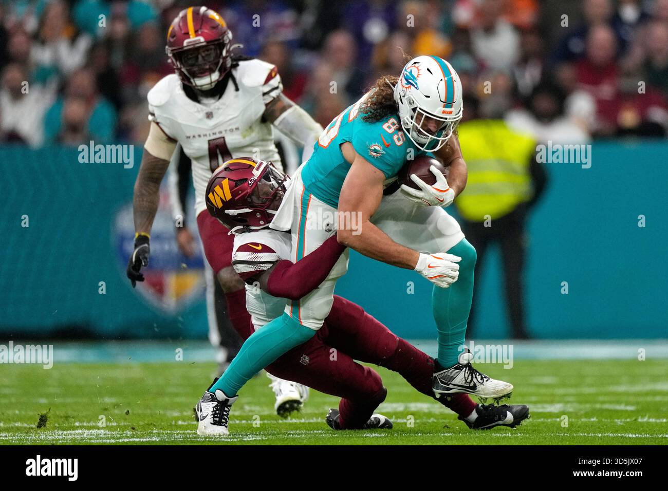Miami Dolphins tight end Greg Dulcich (85) is tackled during the first ...