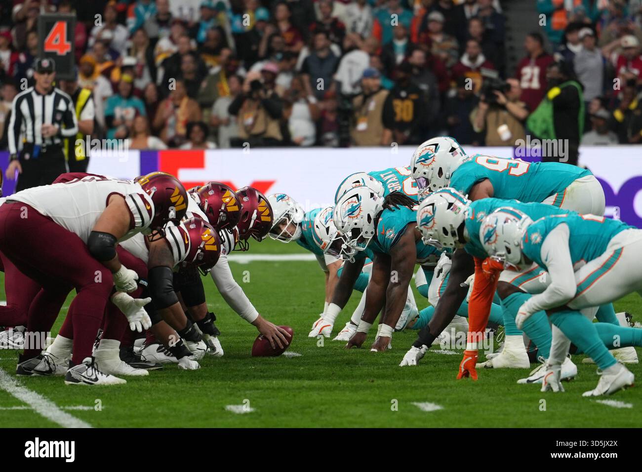 Washington Commanders and Miami Dolphins players get set for a play in ...