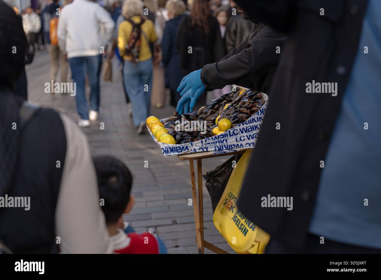 16 November 2025, Turkey, Istanbul: A vendor sells mussels, known ...