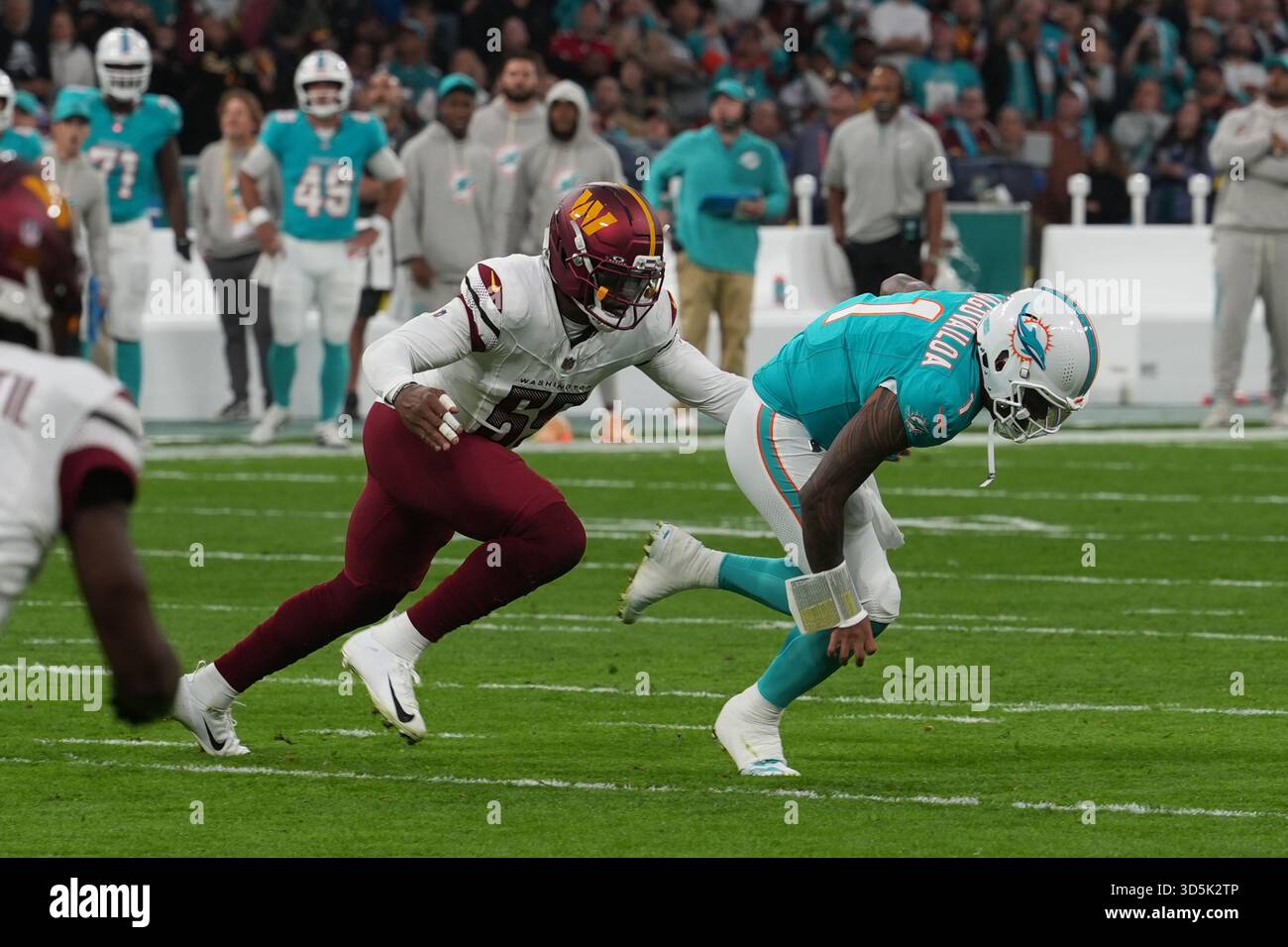 Washington Commanders defensive end Jacob Martin (55) stops Miami ...