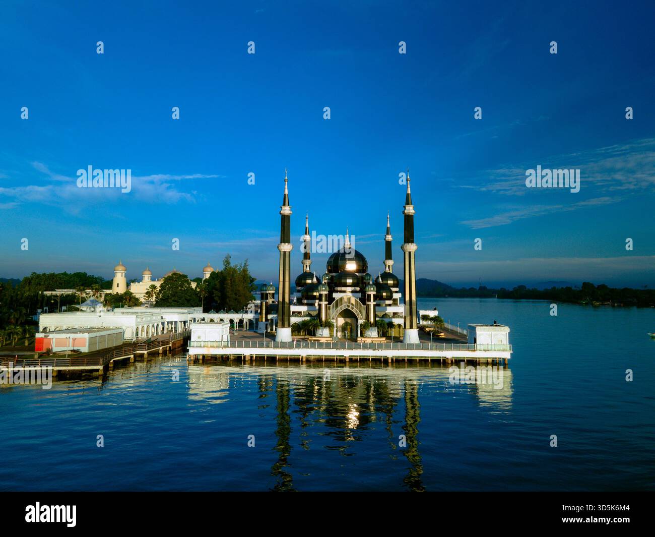 Aerial view of the Crystal Mosque at sunrise, with golden light ...