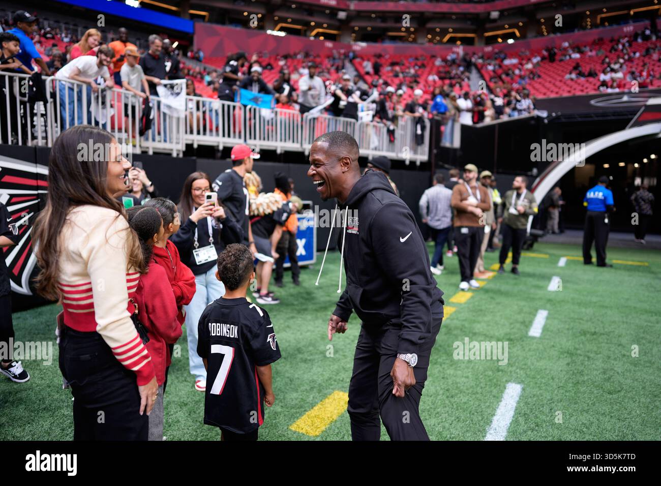 Atlanta Falcons head coach Raheem Morris laughs on the field before an ...