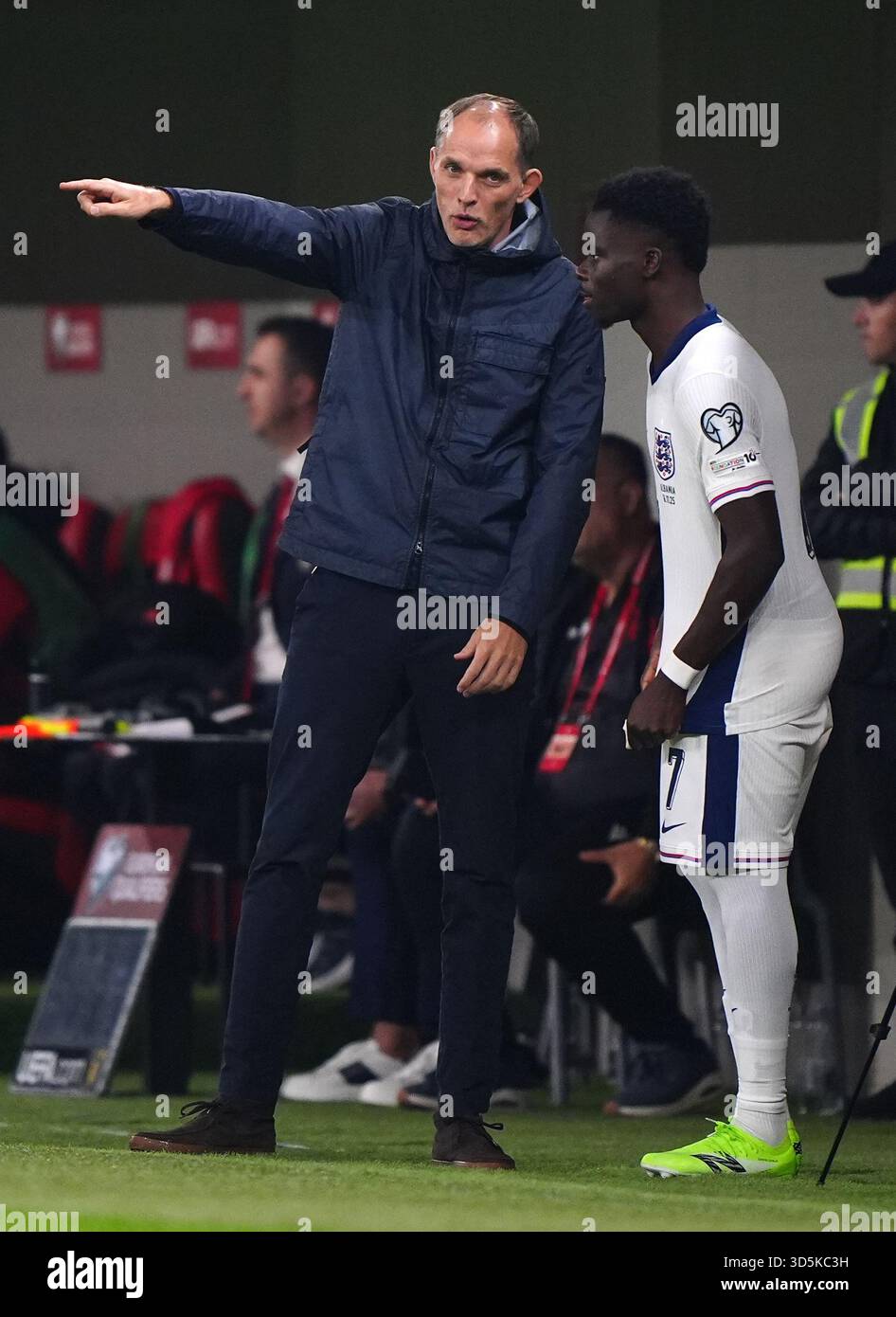 England head coach Thomas Tuchel (left) speak with player Bukayo Saka ...