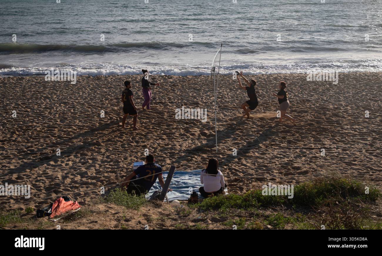 16 November 2025, Spain, Palma: People playing beach volleyball on Can ...