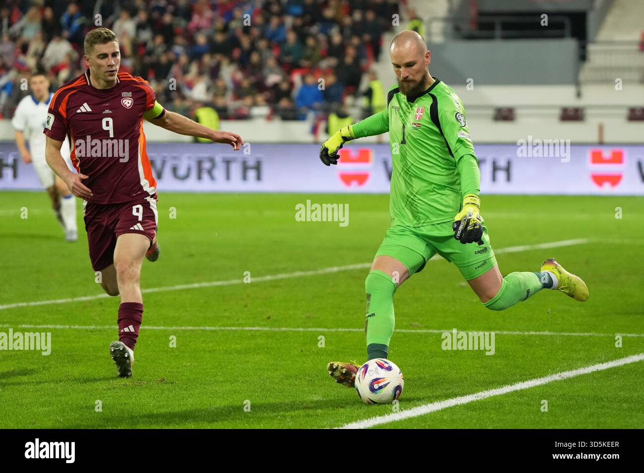 Serbia's goalkeeper Predrag Rajkovic kicks the ball under pressure from ...