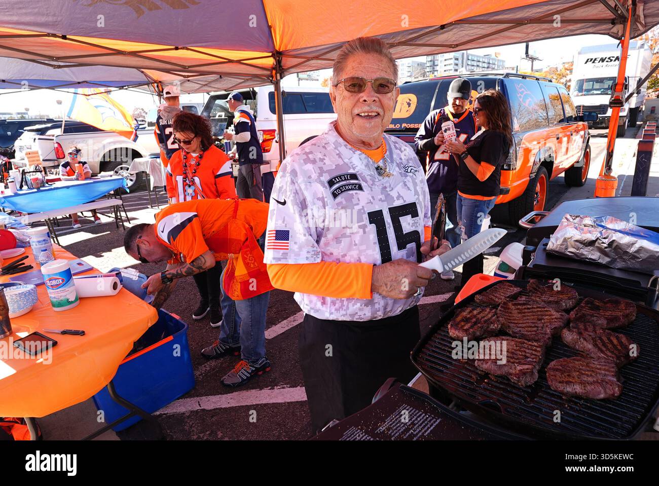 Henry Alire of Pueblo, Colo., cooks for a tailgate party outside ...