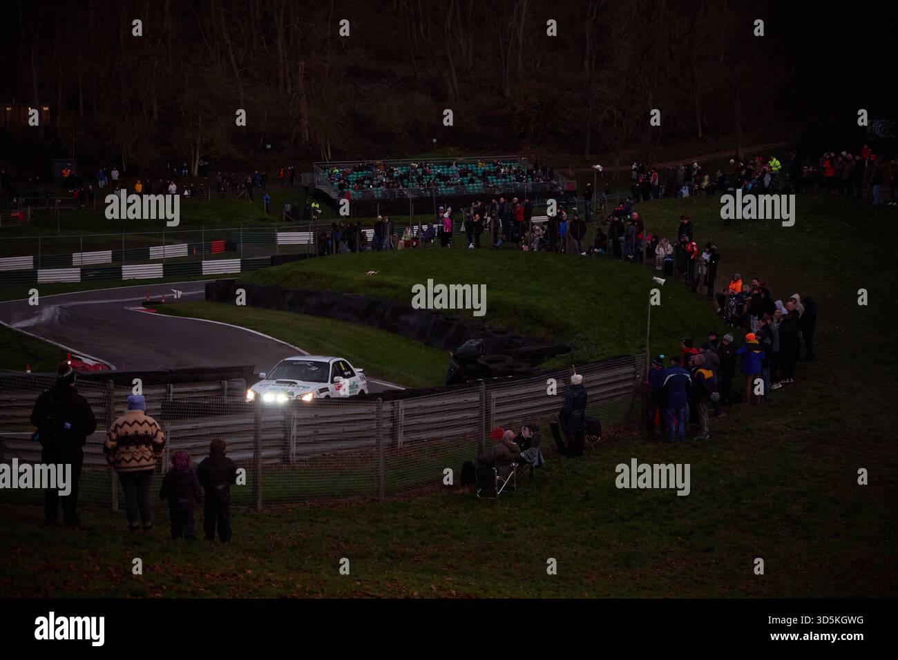 Car 0 checks the track as crowds prepar for the night racing at North ...