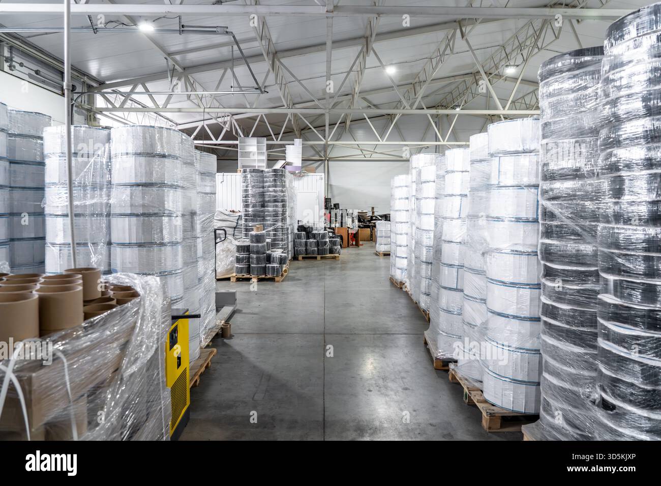 Industrial warehouse with large rolls of packaging film and plastic ...