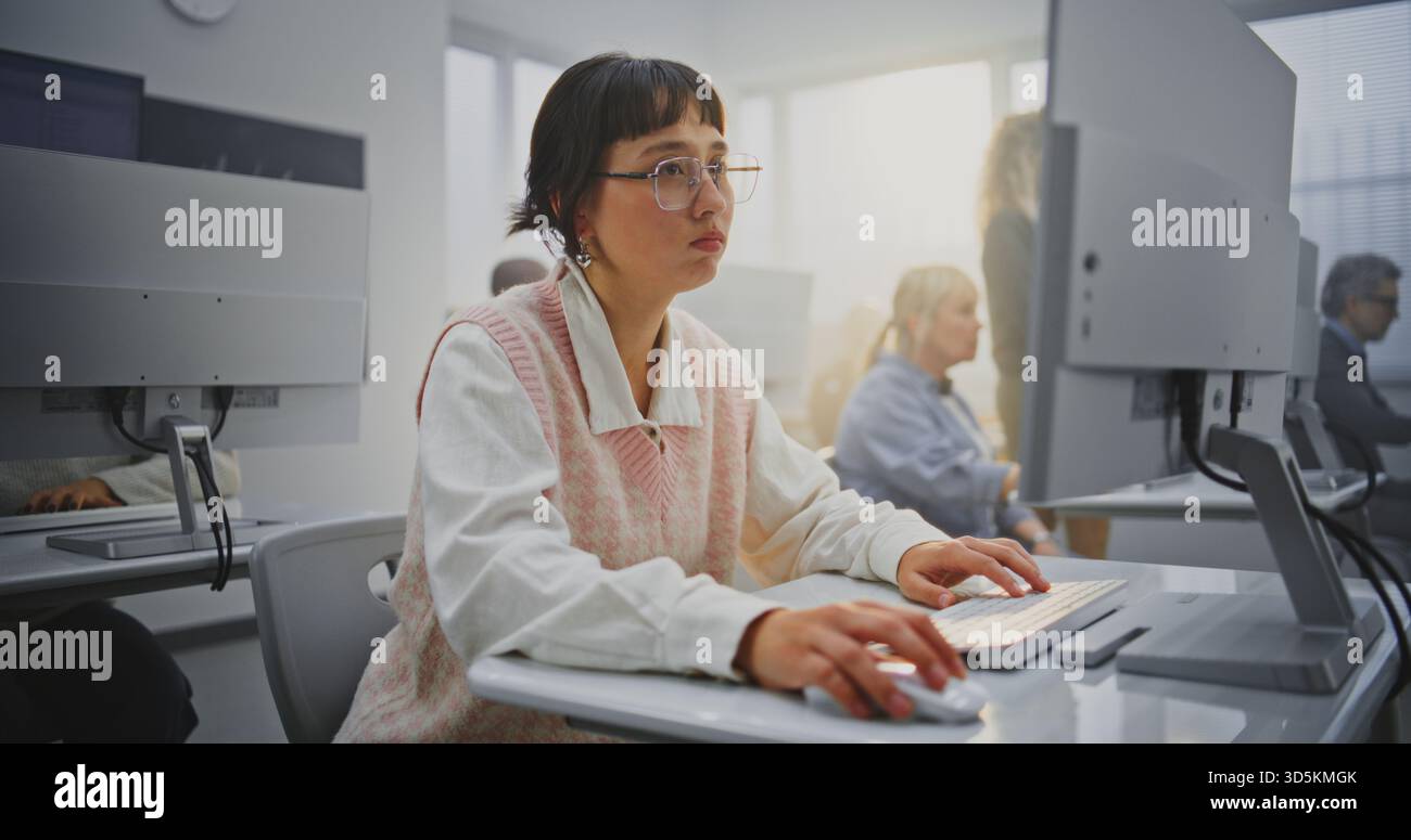 Focused on Screen South Asian Woman in Glasses Sits at Computer During ...