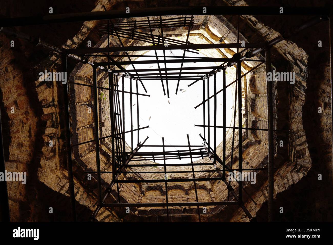 Upward perspective inside an ancient stone structure showing protective ...