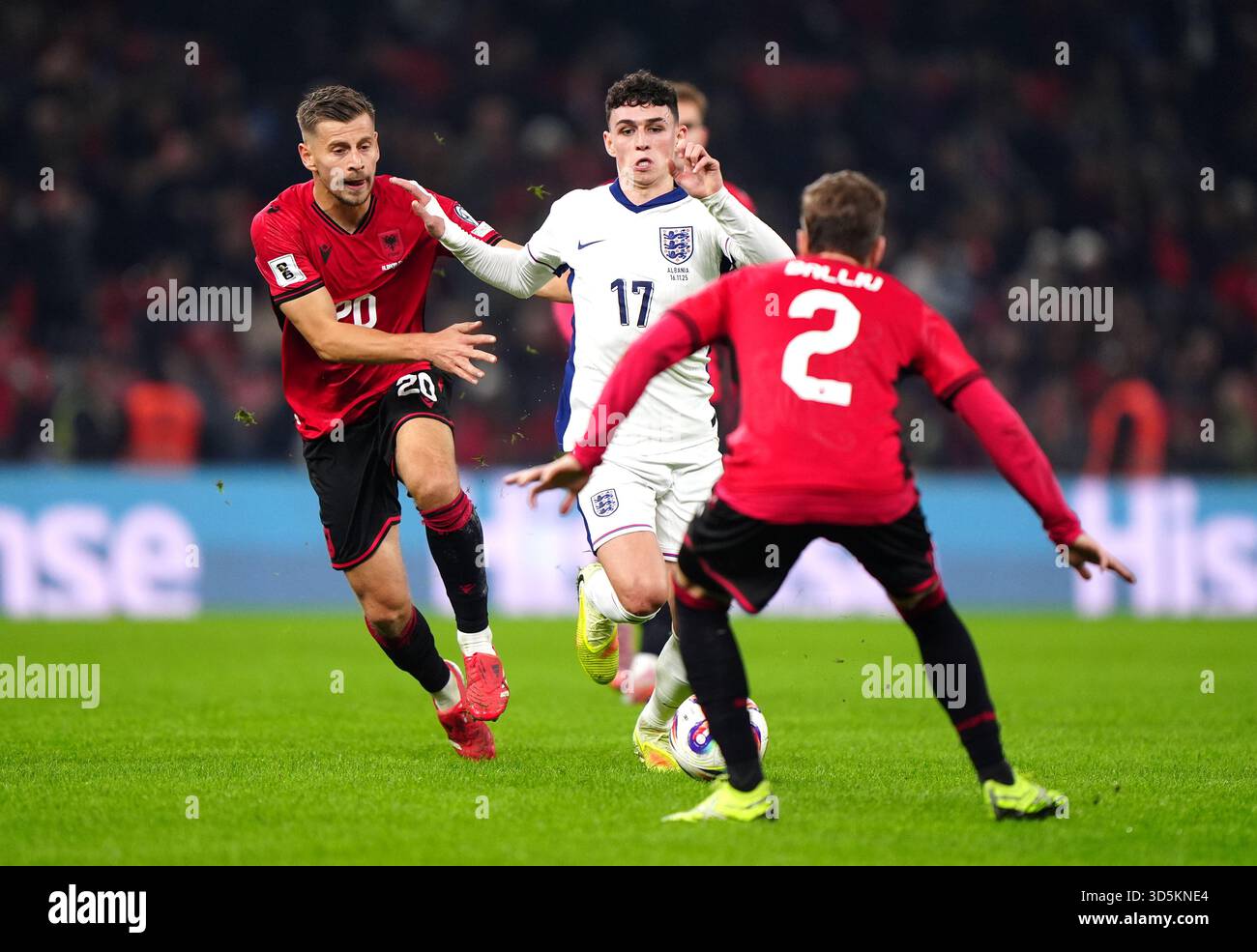 England's Phil Foden (centre) battles for the ball with Albania's Ylber ...