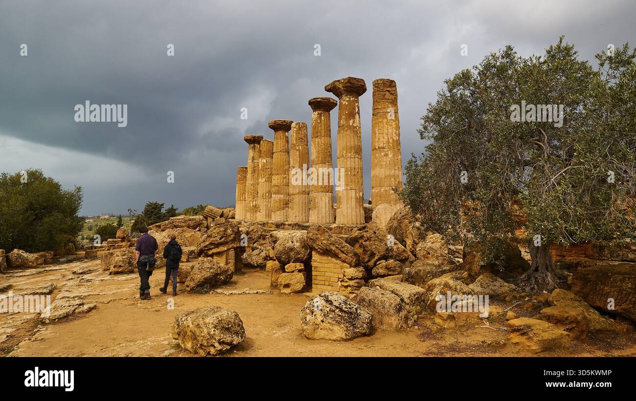 Heracles Temple, Ancient Column Ruins with Two People and Stormy Sky ...