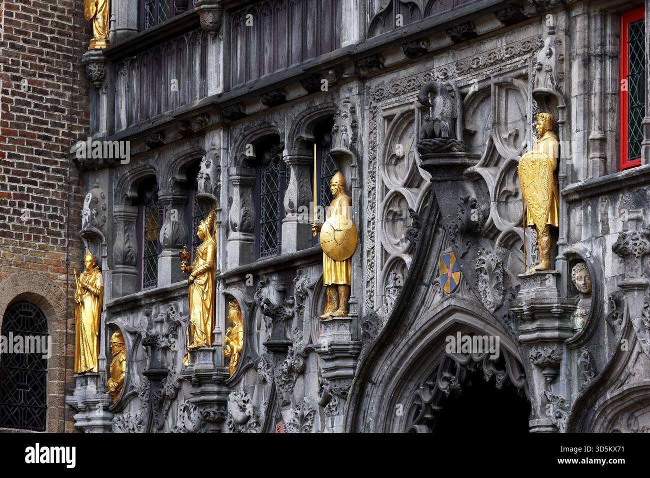 Richly decorated facade and entrance portal with golden figures to the ...