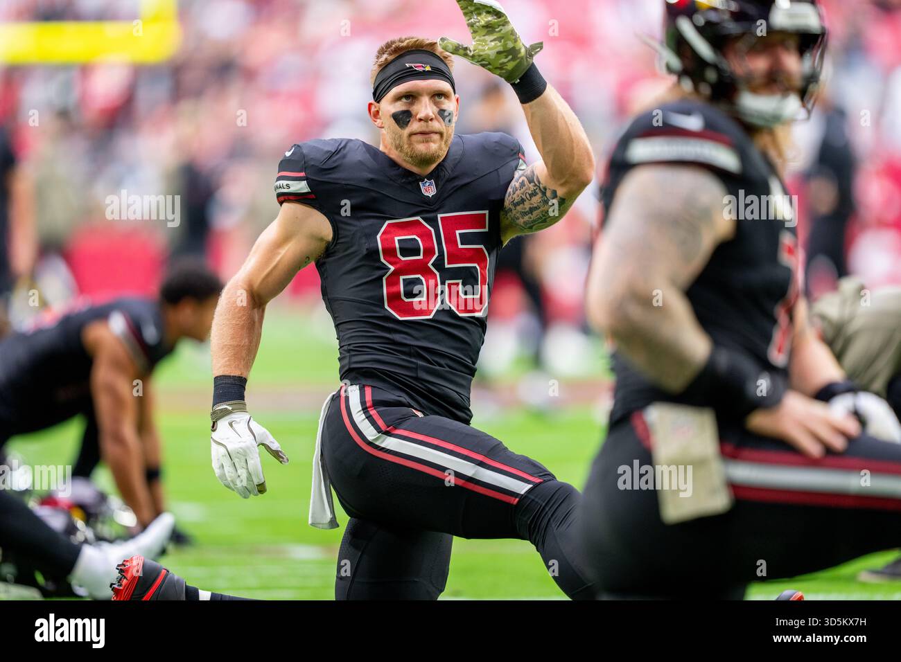 Arizona Cardinals tight end Trey McBride (85) stretches before an NFL ...