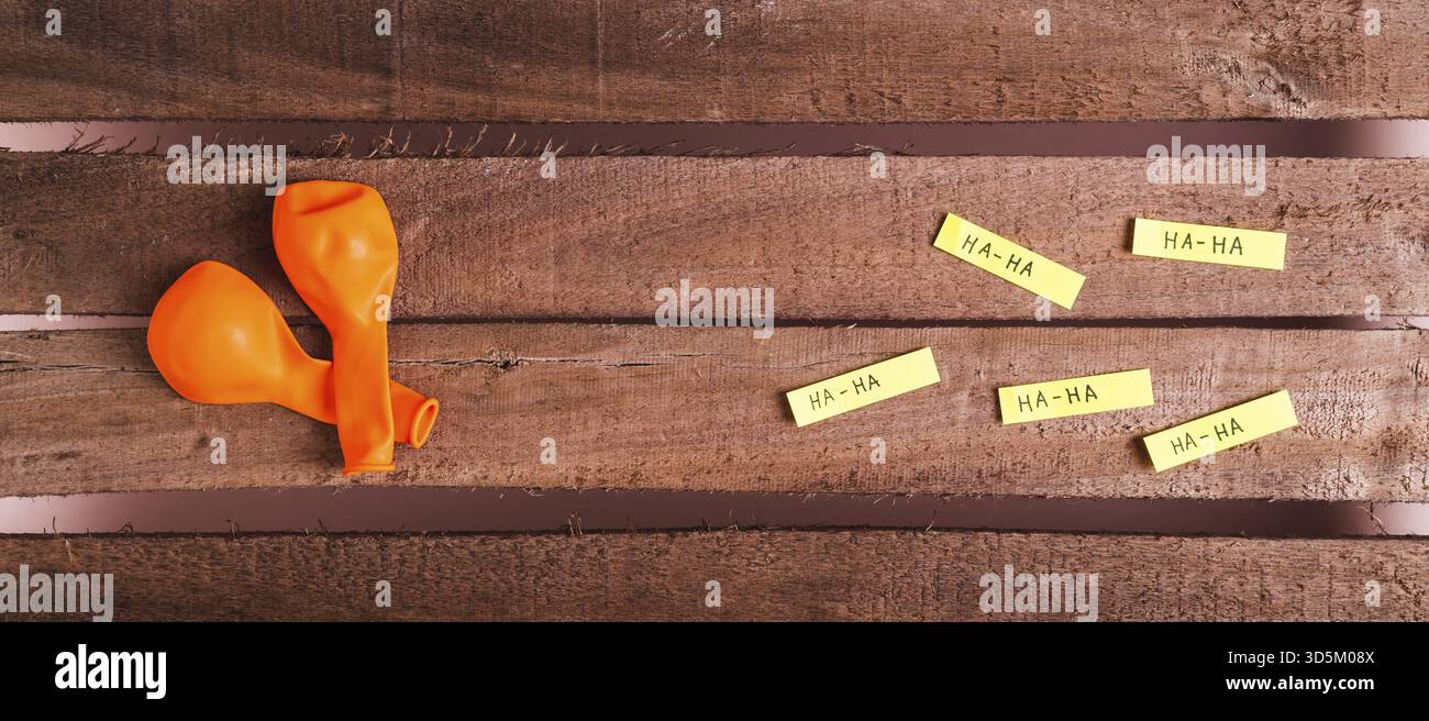 Happy April Fools Day, balloons and funny notes on wooden top view web ...