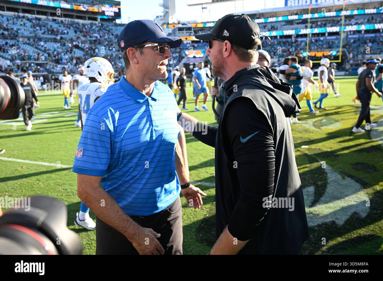 Jacksonville Jaguars head coach Liam Coen, right, talks with Los ...
