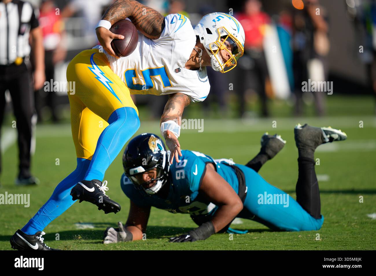 Los Angeles Chargers quarterback Trey Lance (5) escapes Jacksonville ...