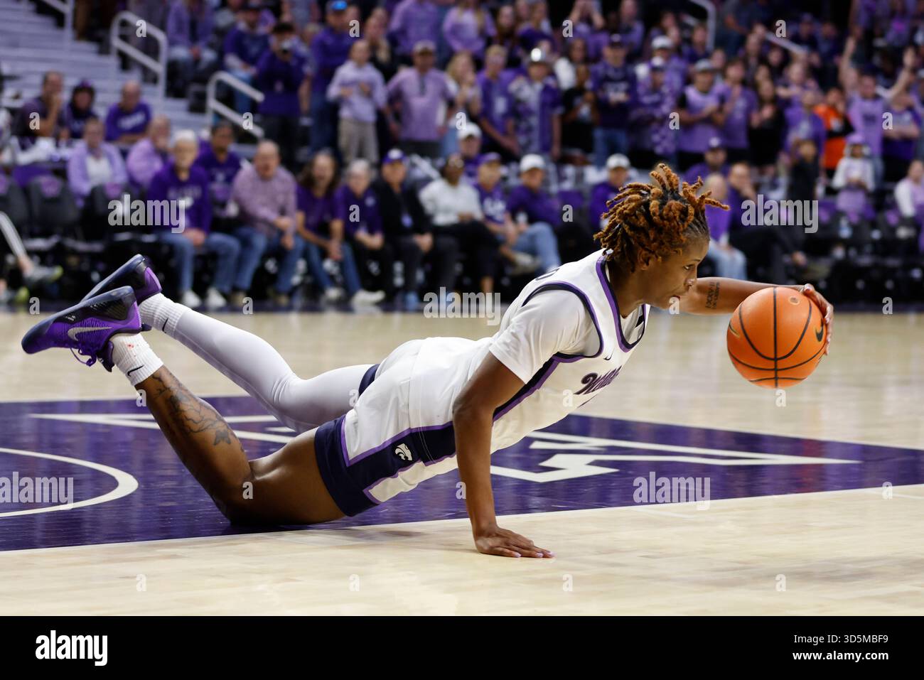 Kansas State guard Brandie Harrod dives for the ball after having her ...