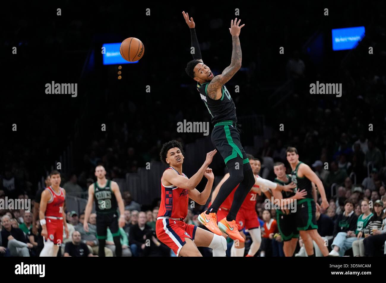 Boston Celtics Anfernee Simons, top, misses a pass while being defended ...