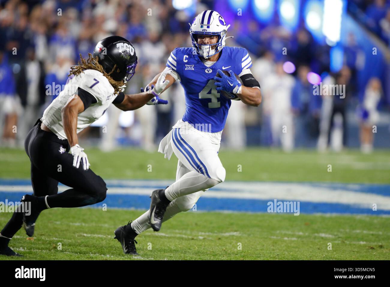 BYU running back LJ Martin (4) runs the ball as TCU cornerback Channing ...