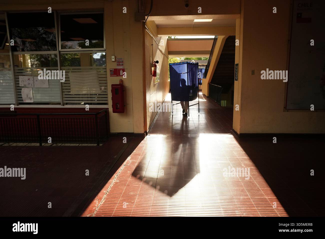A worker carries away a voting booth after polls closed during general ...