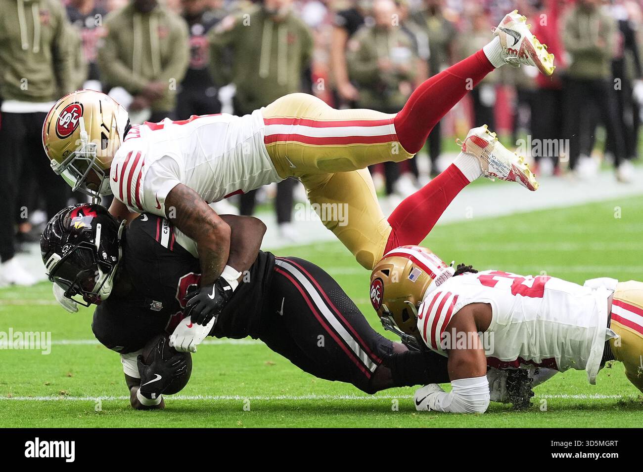 Arizona Cardinals running back Michael Carter, bottom, is tackled by ...