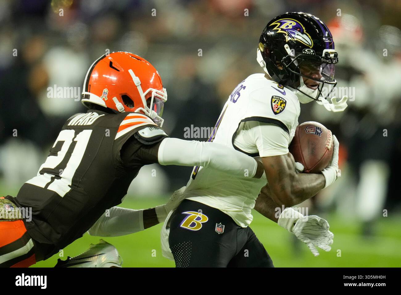 Baltimore Ravens wide receiver Zay Flowers (4) runs from Cleveland Browns cornerback Denzel Ward ...