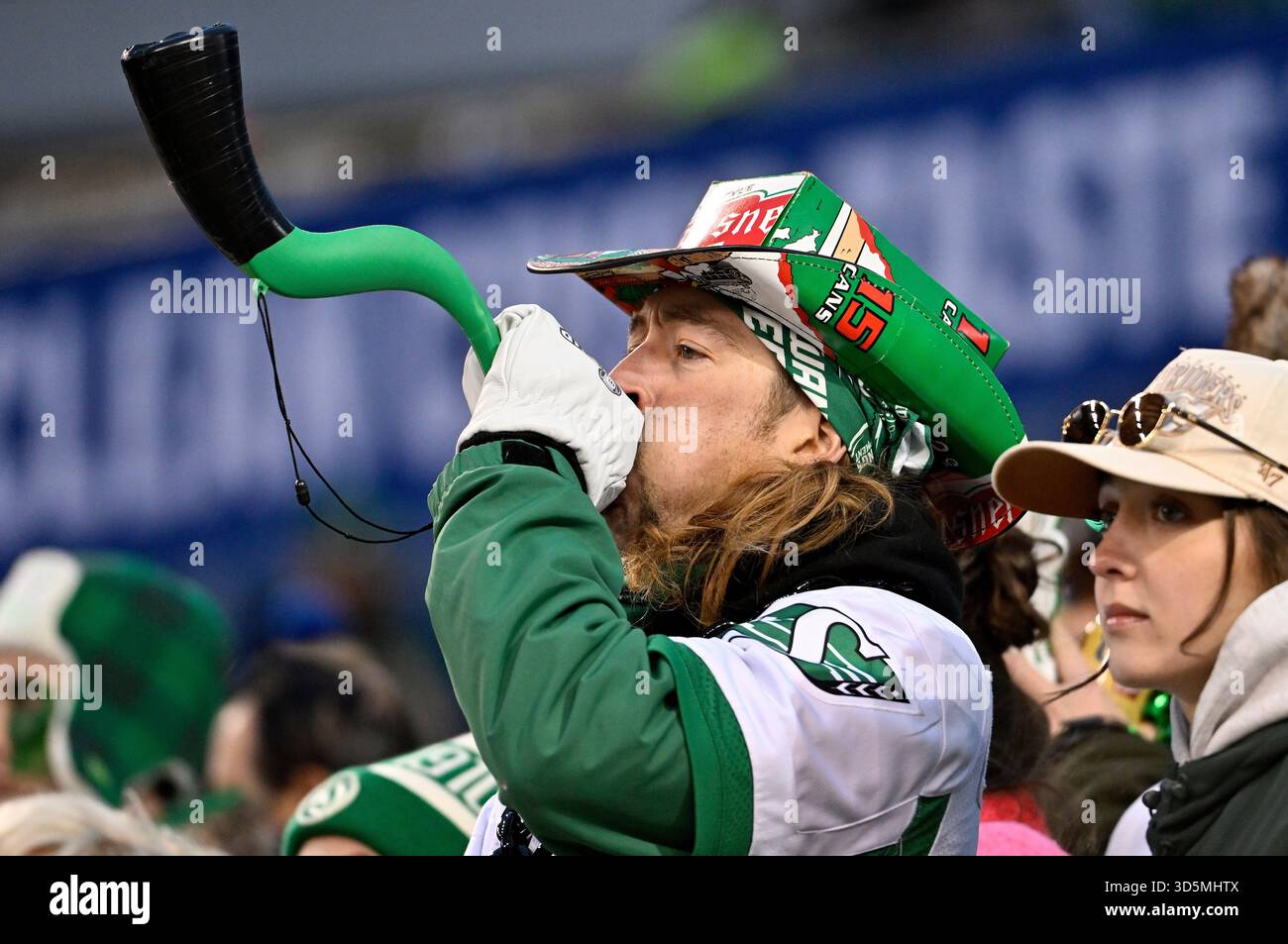 A Saskatchewan Roughriders fan blows a horn prior to first half CFL ...