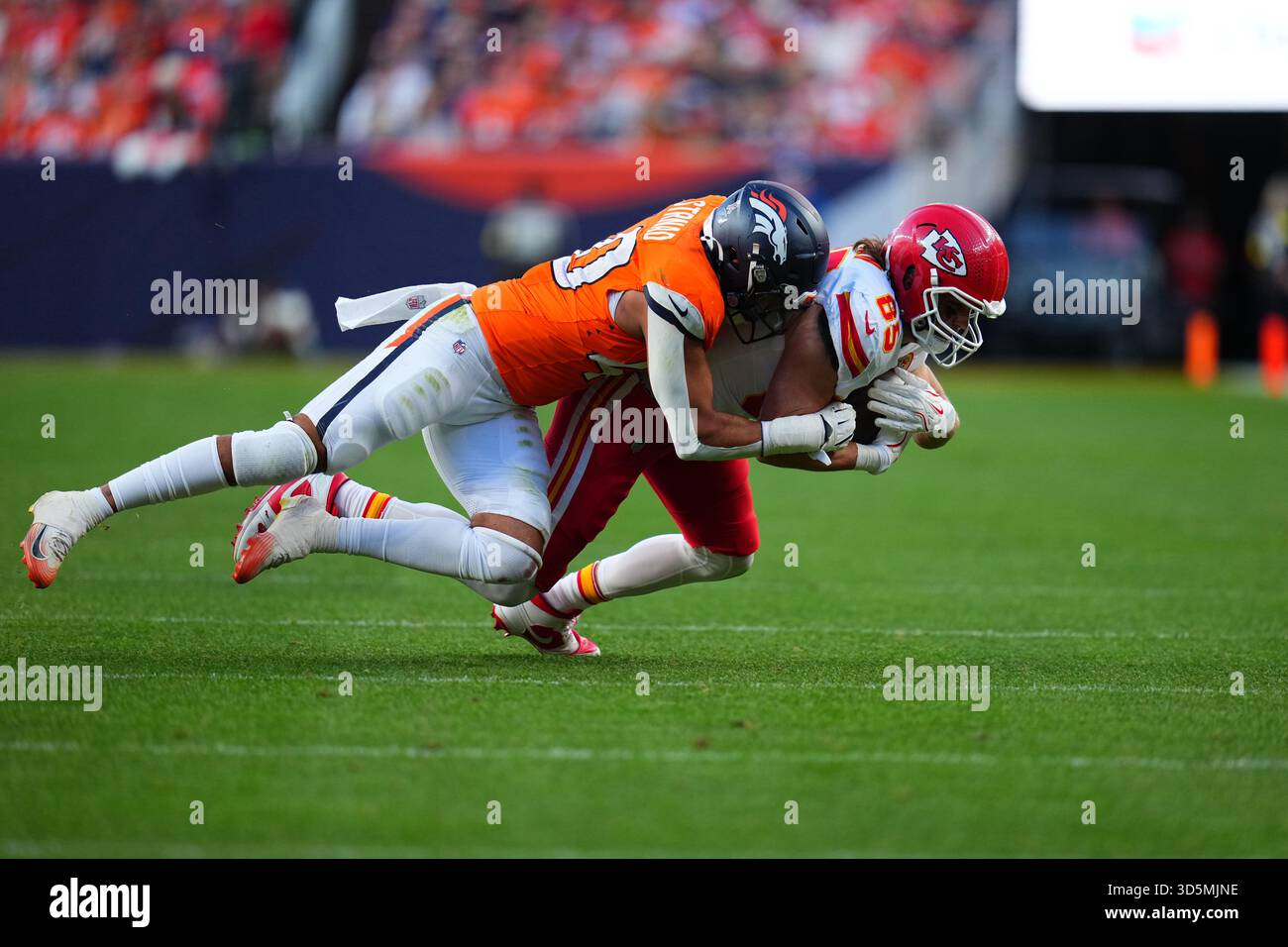 Kansas City Chiefs tight end Robert Tonyan, right, is tackled by Denver ...