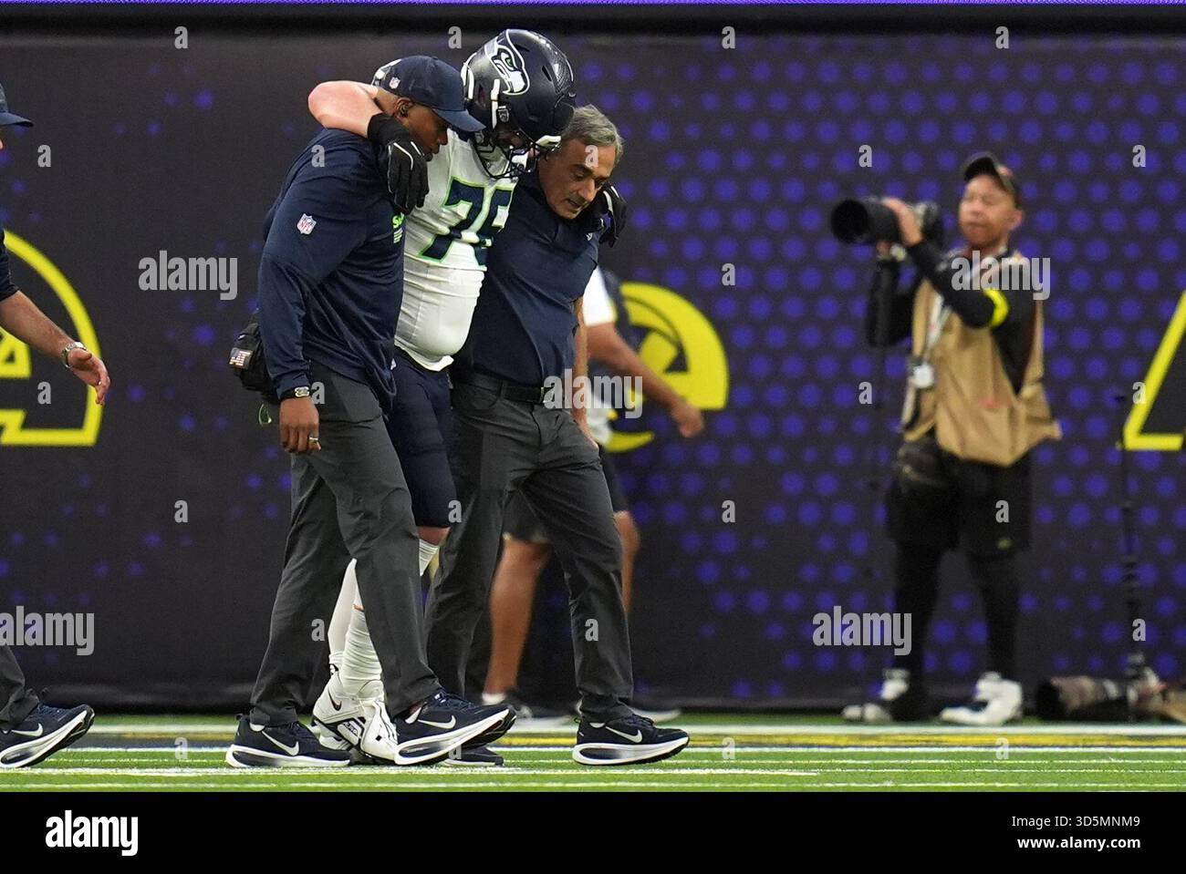 Seattle Seahawks guard Grey Zabel is helped off the field after being ...