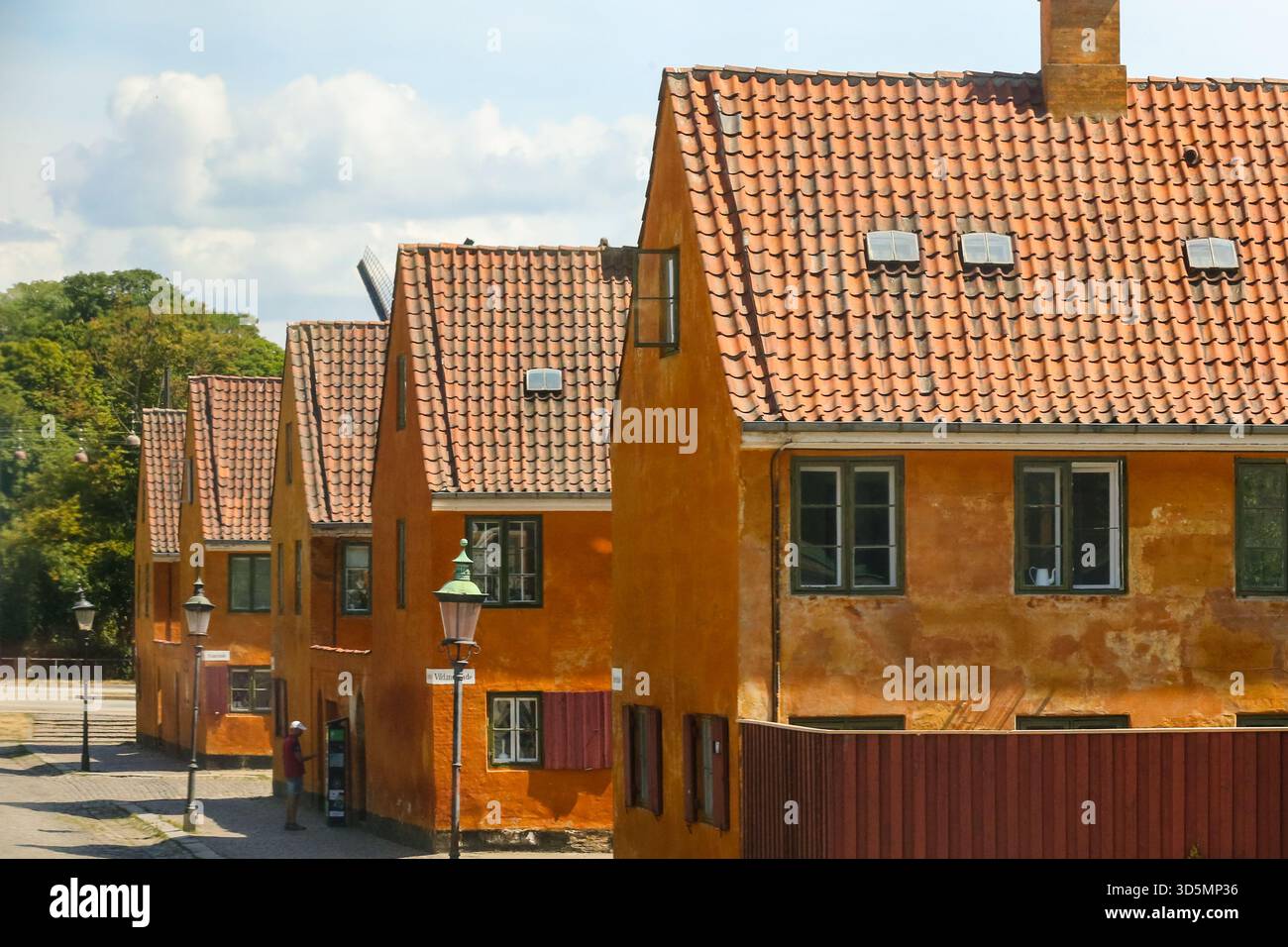 Historic yellow Nyboder row houses in Copenhagen with tiled roofs and ...