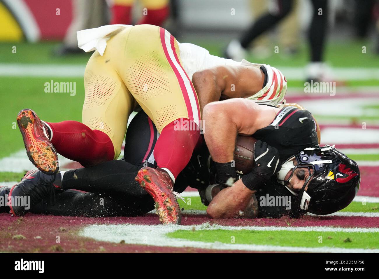 Arizona Cardinals tight end Trey McBride, bottom, scores against the ...