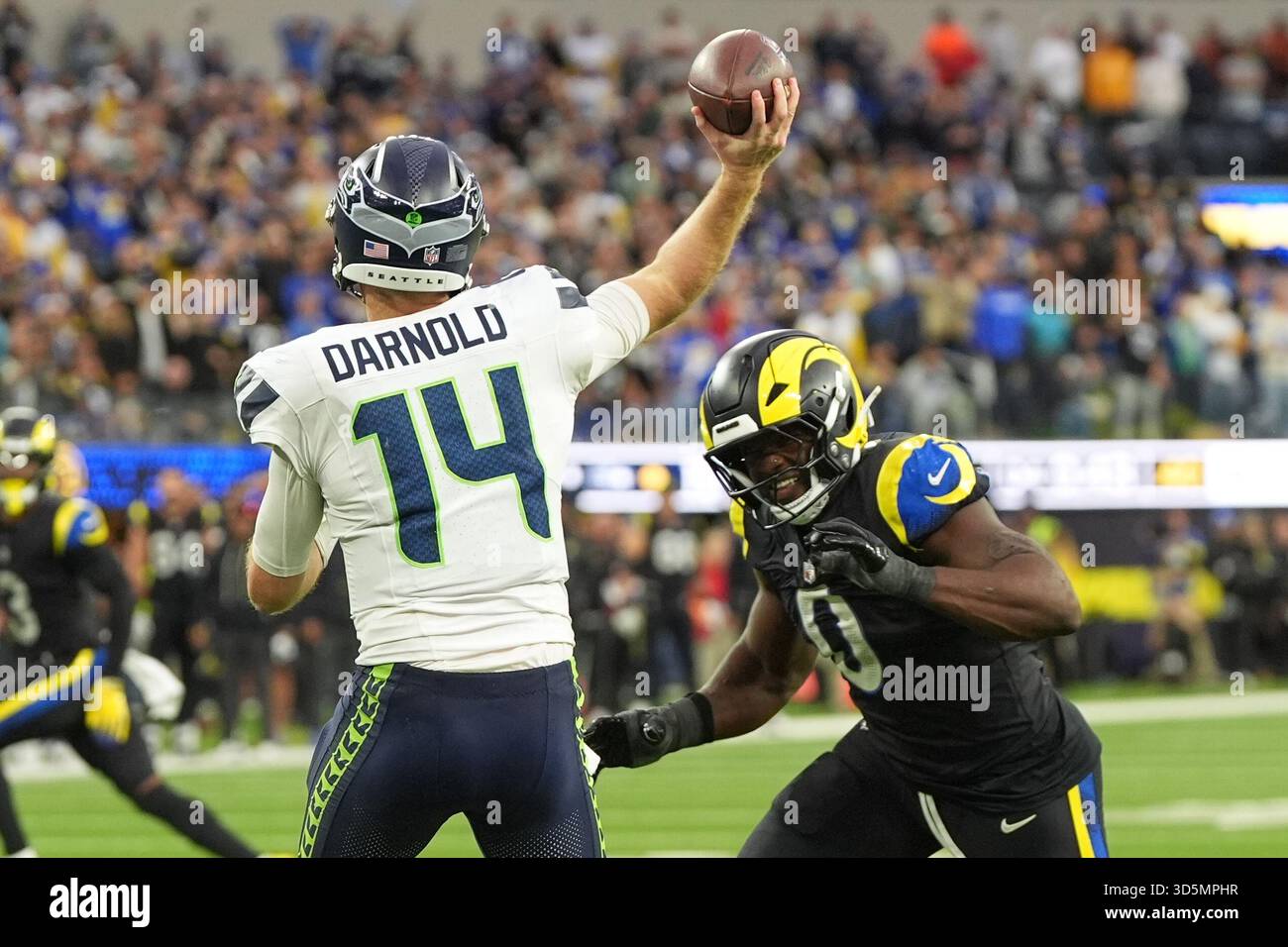 Seattle Seahawks quarterback Sam Darnold, let, passes while under ...