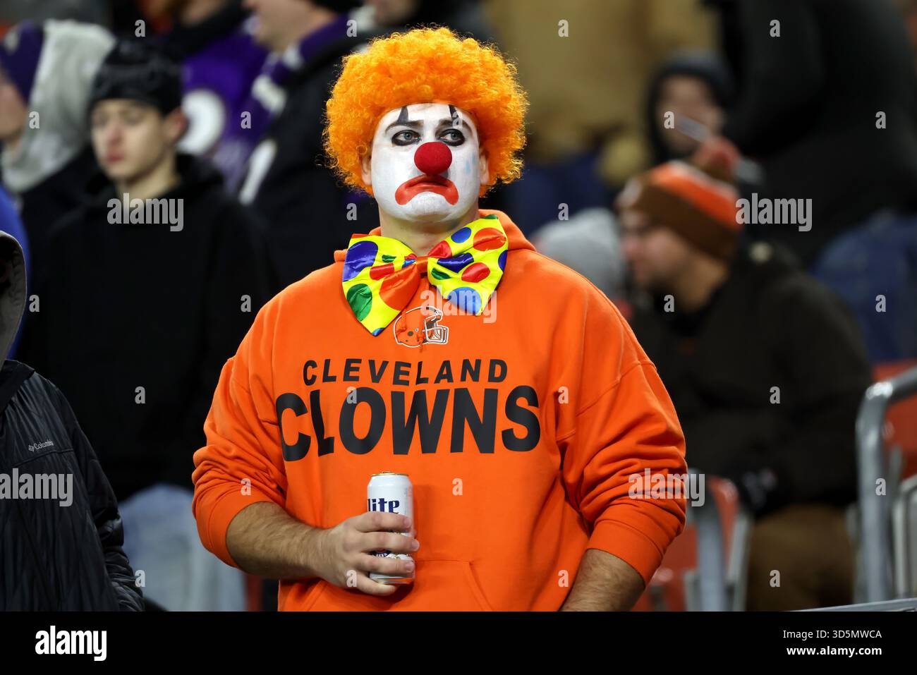 A Cleveland Browns fan dressed as a clown watches from the stands ...
