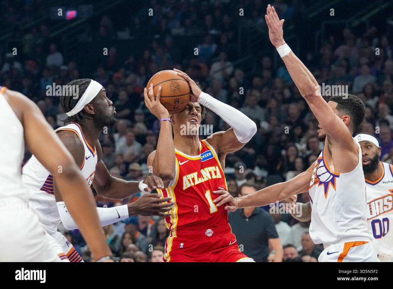 Atlanta Hawks forward Jalen Johnson, center, gets double teamed by ...