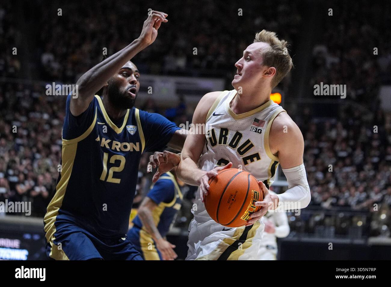 Purdue guard Fletcher Loyer (2) drives on Akron guard Evan Mahaffey (12 ...